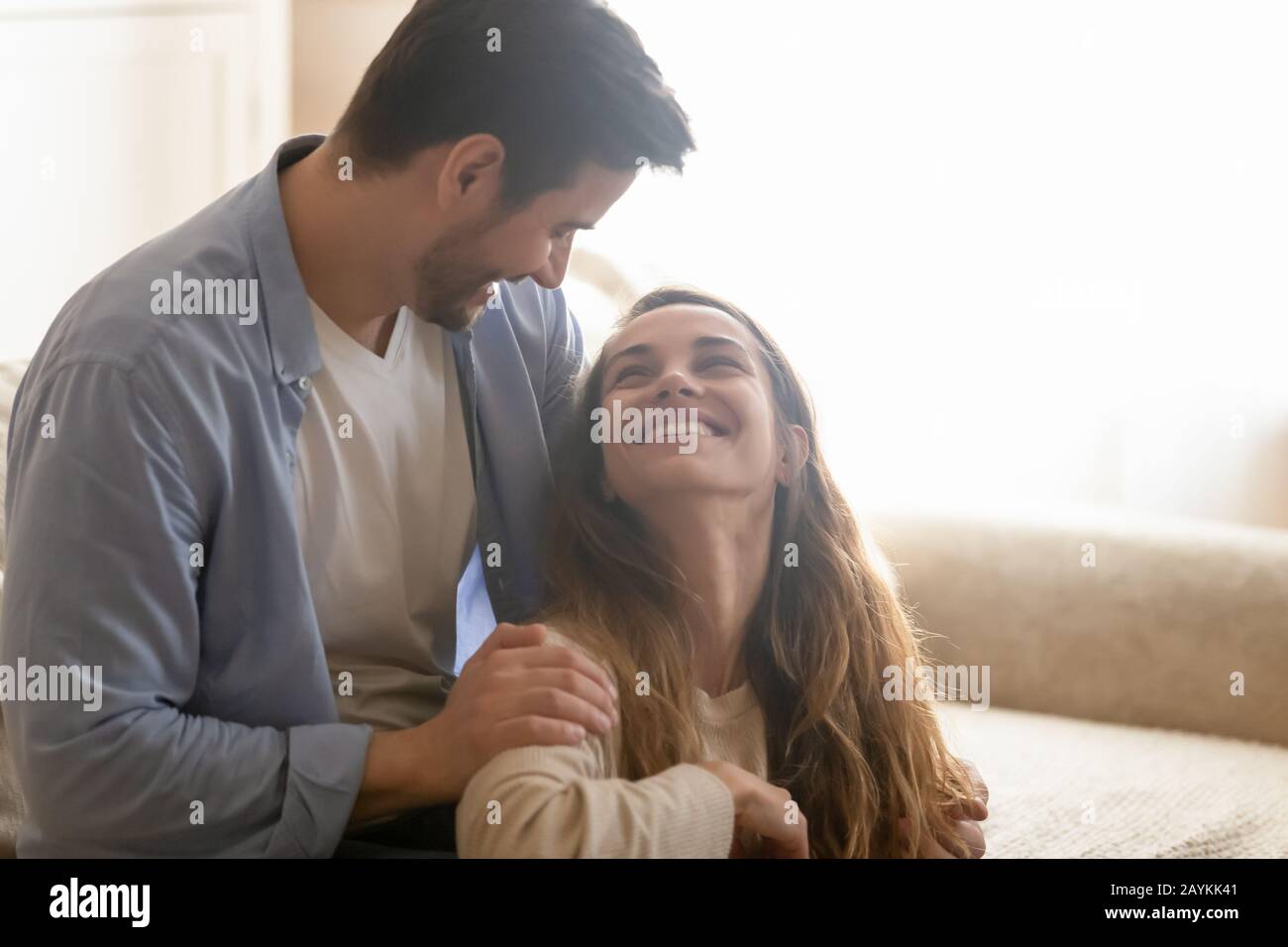 Happy young couple cuddle enjoying weekend together Stock Photo - Alamy