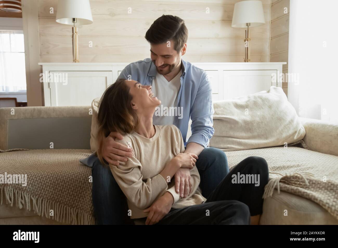 Loving couple cuddle enjoy romance in living room Stock Photo - Alamy