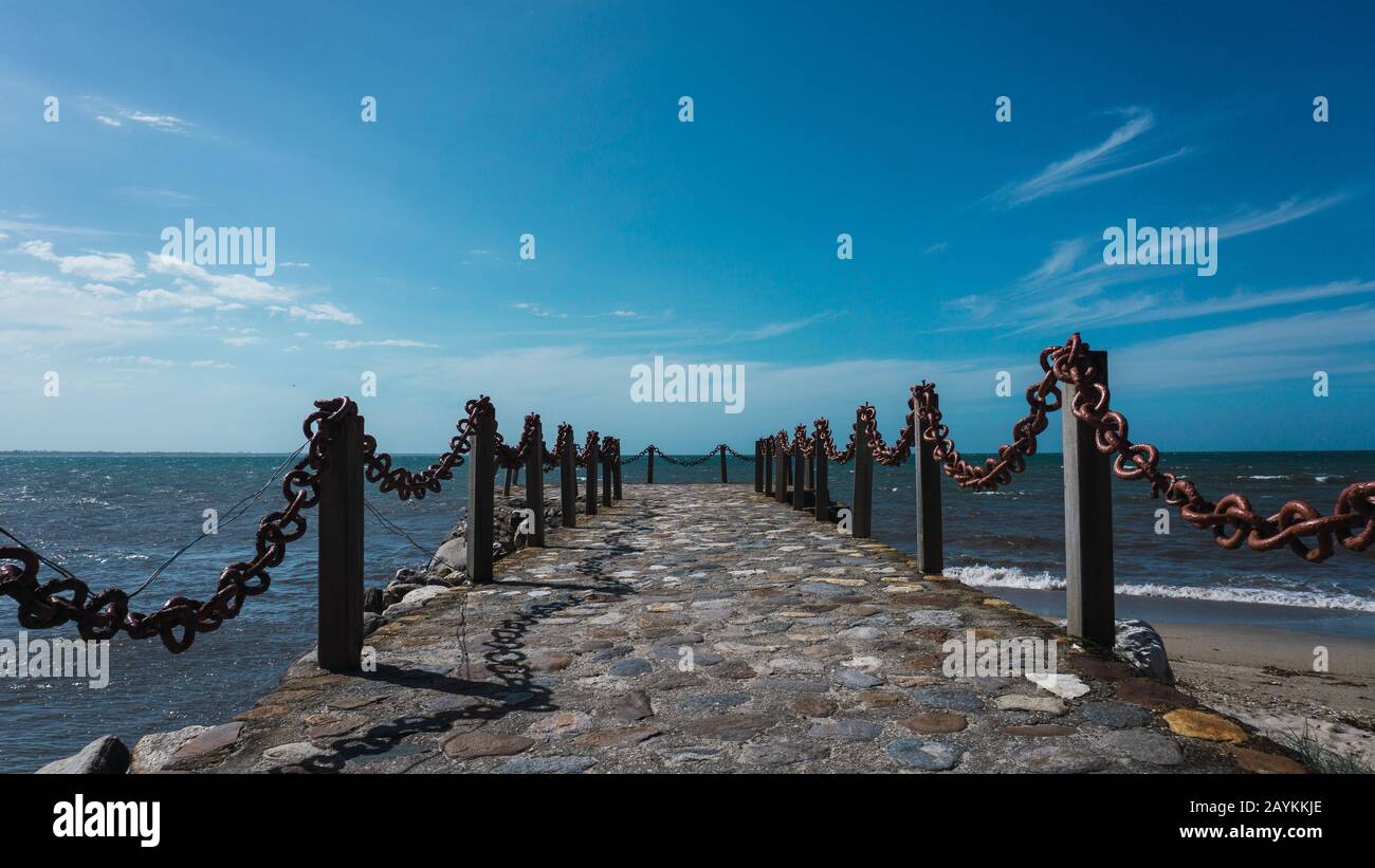 Beautiful view on the pier with a blue sky and ocean Stock Photo - Alamy