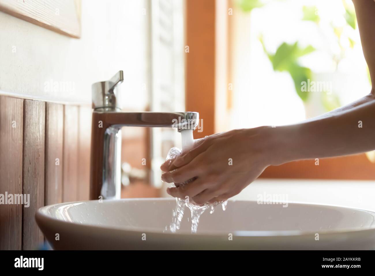 Woman wash hands do morning cleanup in bathroom Stock Photo - Alamy