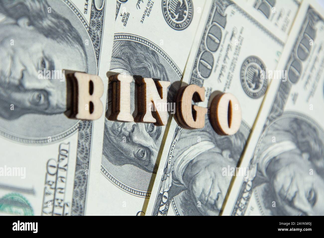 The word BINGO with wooden letters on the US dollar bills background ...