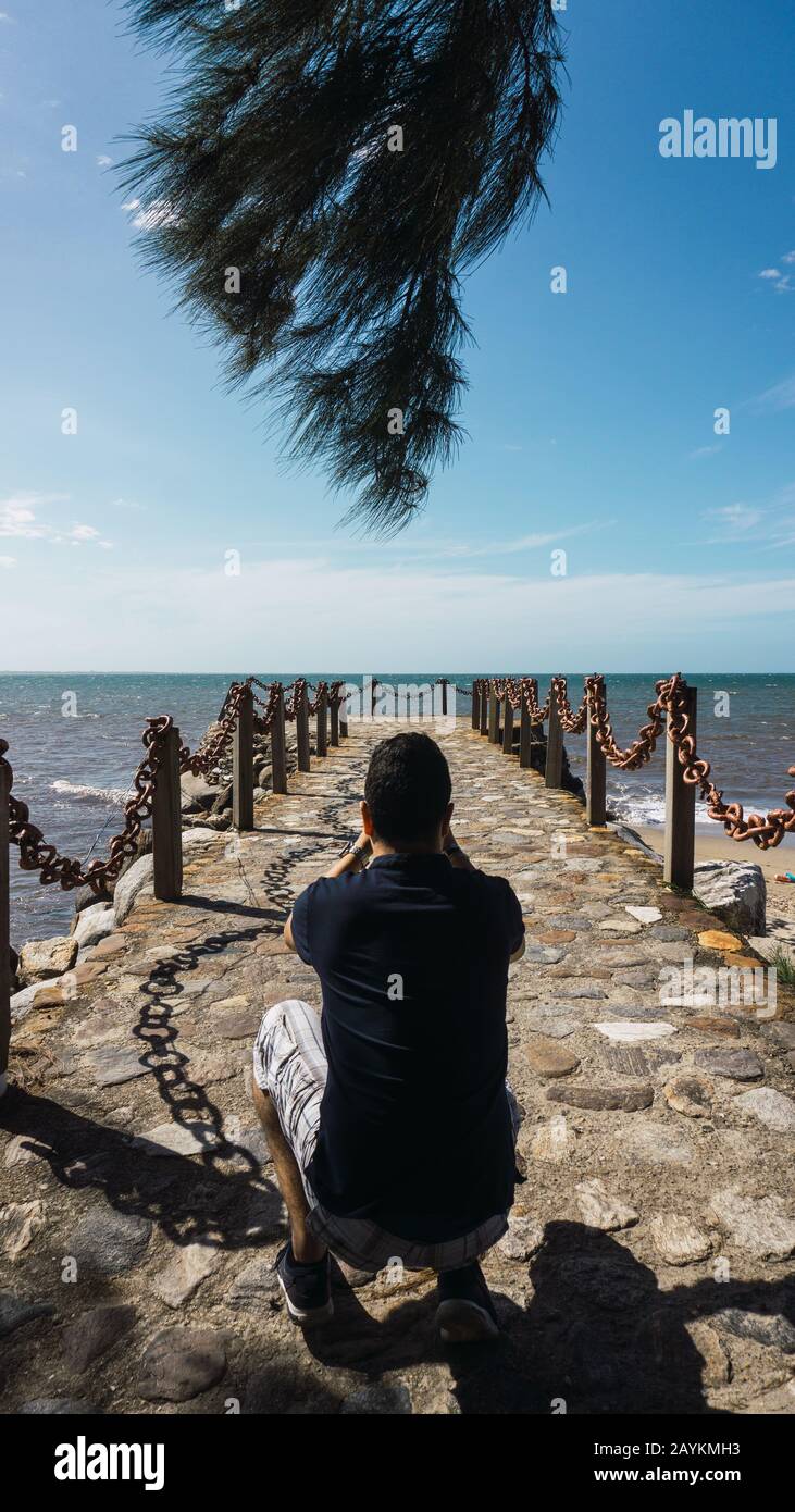 Photographer taking a photo on the pier with a pretty sea view Stock ...