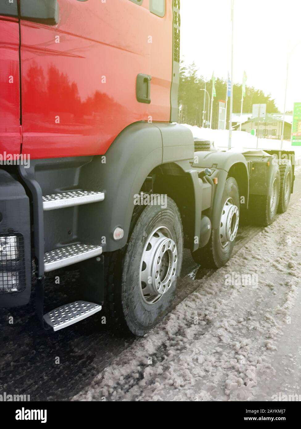 Red heavy truck without a trailer is on the side of the snow covered ...