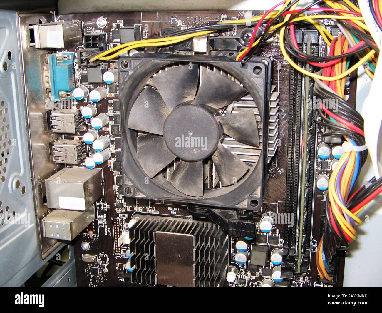 Dust on the computer pc processor cooler with mainboard and computer case fragment. Selective ...