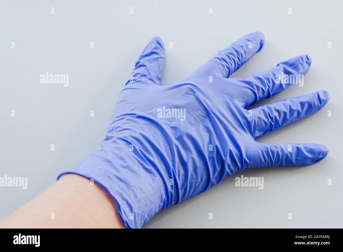 Human hand in blue latex glove, personal protective equipment medical ...