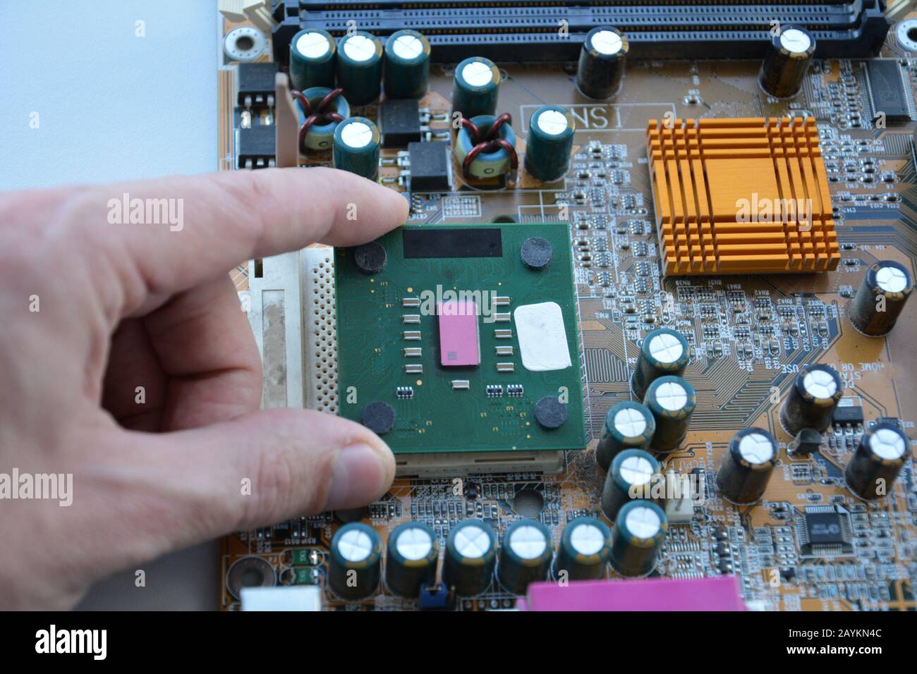 Hand of computer engineering plugging computer cpu processor memory change components into ...