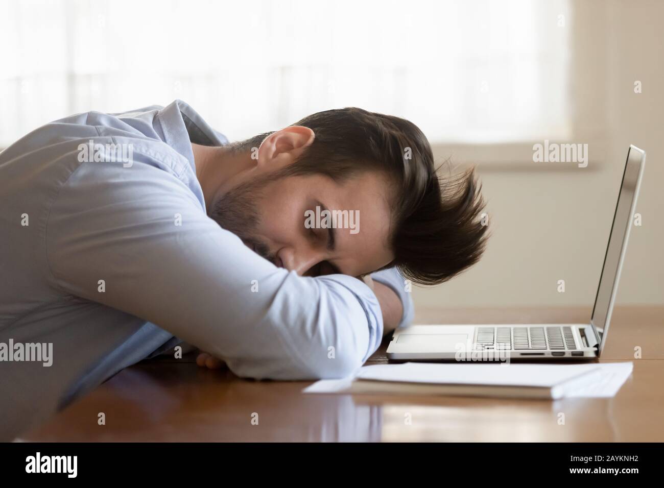 Exhausted male worker fall asleep at workplace Stock Photo - Alamy