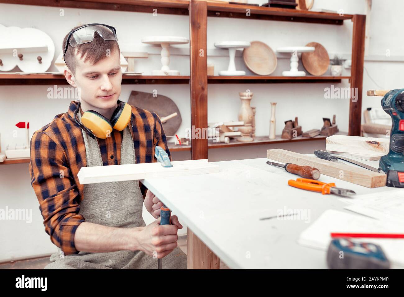 Man carpenter at work in home or workshop. Handcraft experience concept ...
