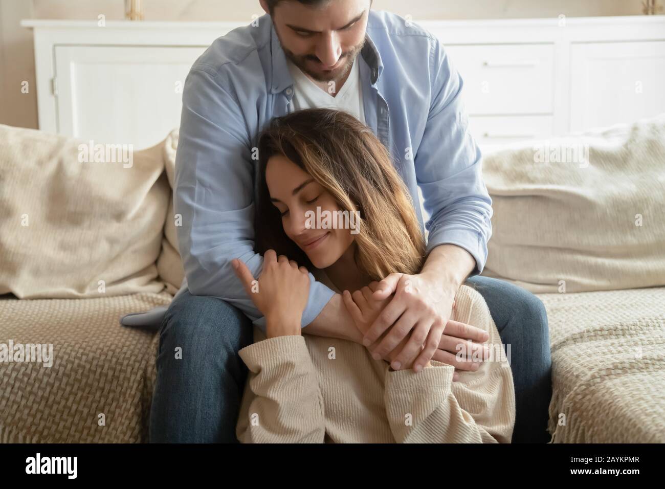 Loving young couple hug relaxing together at home Stock Photo - Alamy