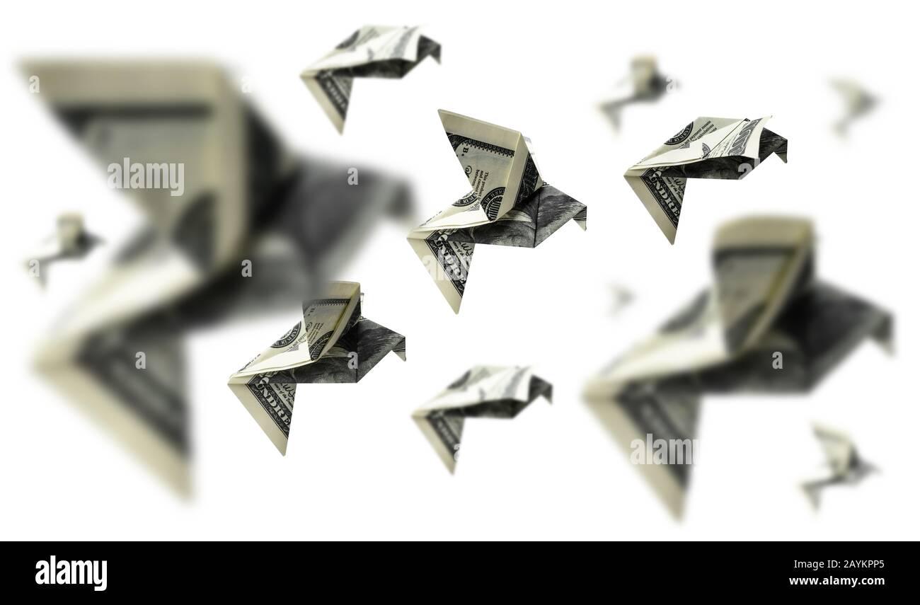 Hundred dollar bills in the shape of birds in flight on a white ...