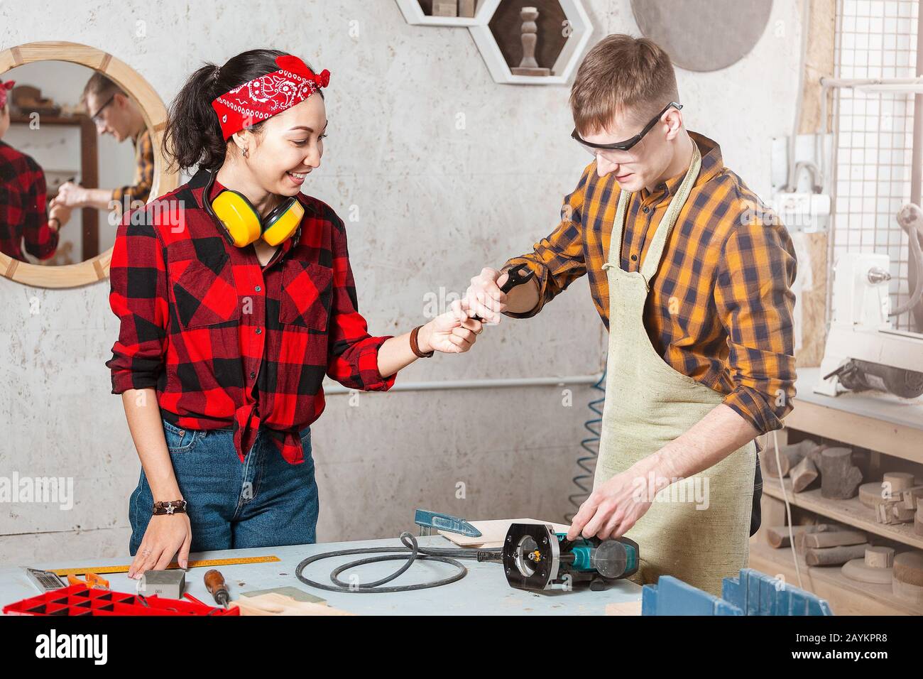 Man and woman carpenters working together in a wood workshop ...