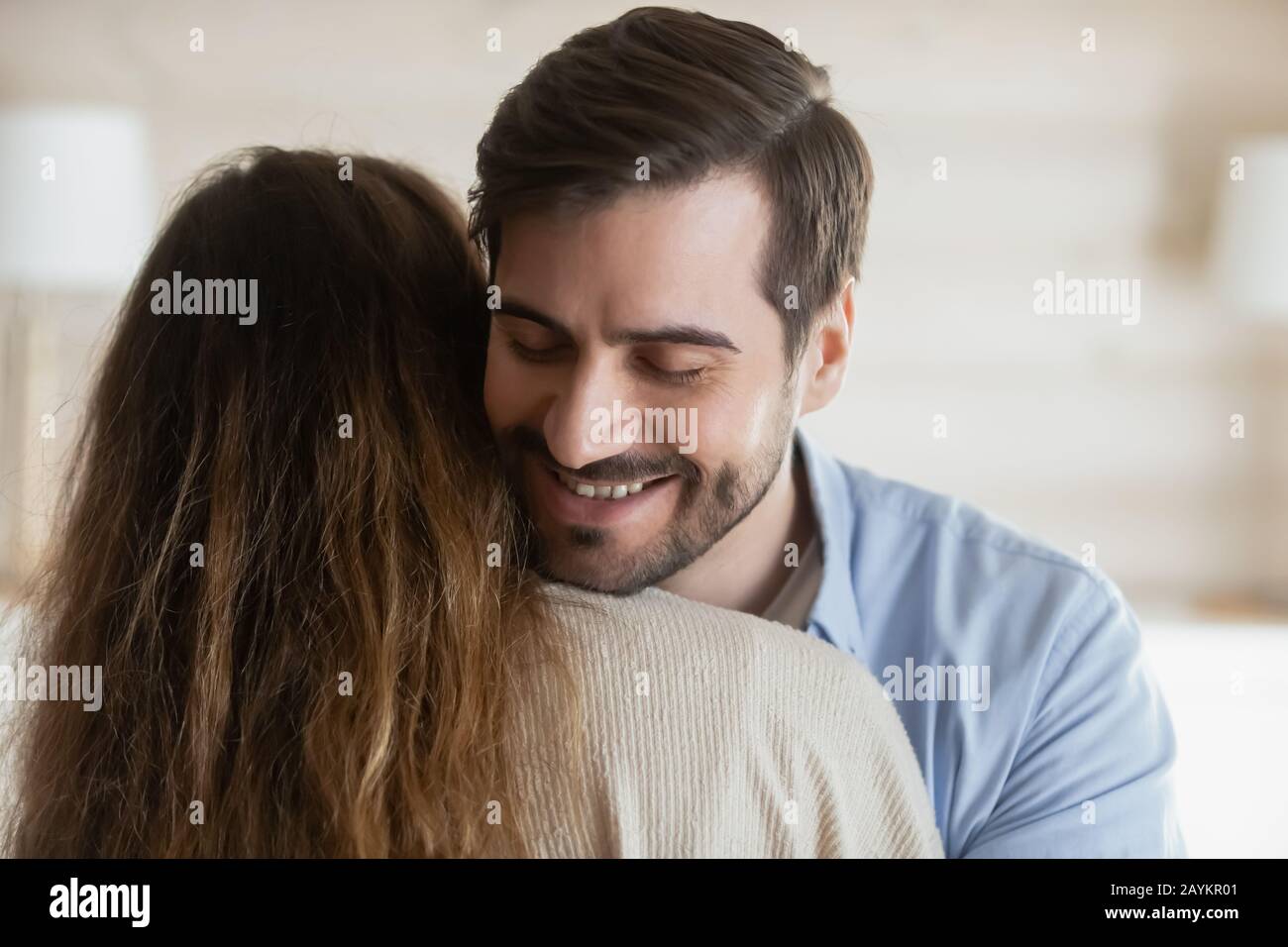 Smiling man hug beloved wife reconcile after fight Stock Photo - Alamy