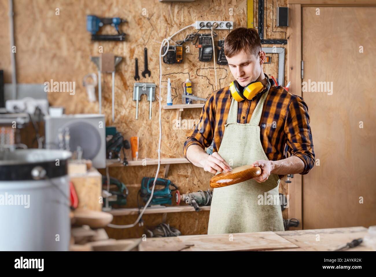 Happy talented caucasian carpenter working with wood in workshop, art ...