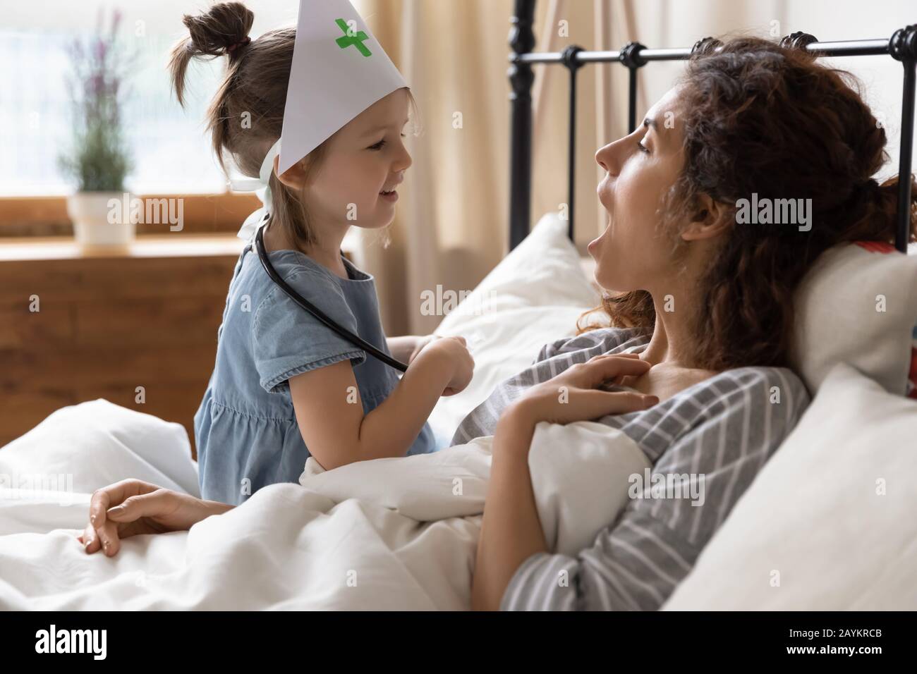 Joyful young mother playing therapist patient with mother Stock Photo ...