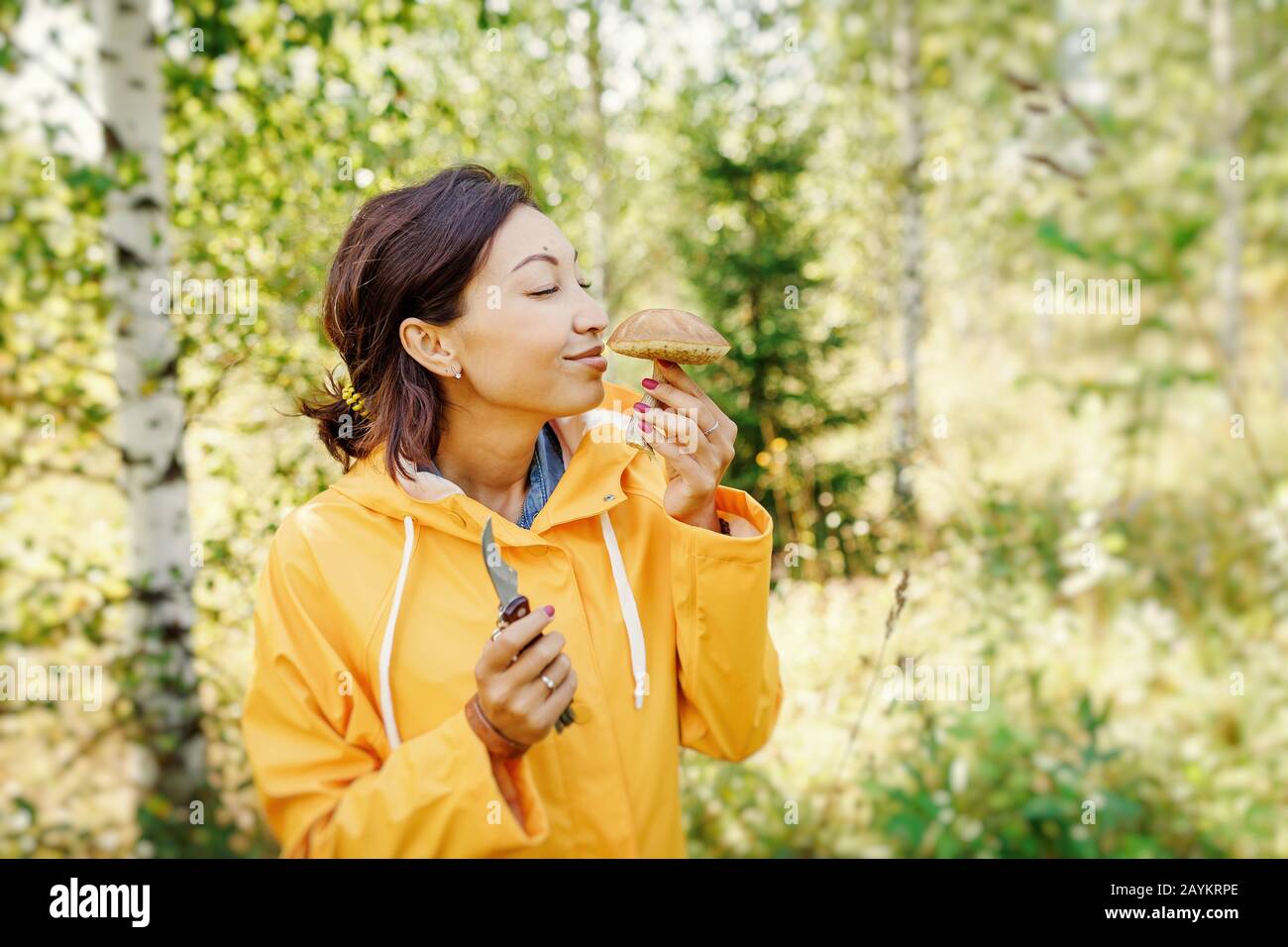 Young girl hunting for mushrooms in the forest Stock Photo - Alamy