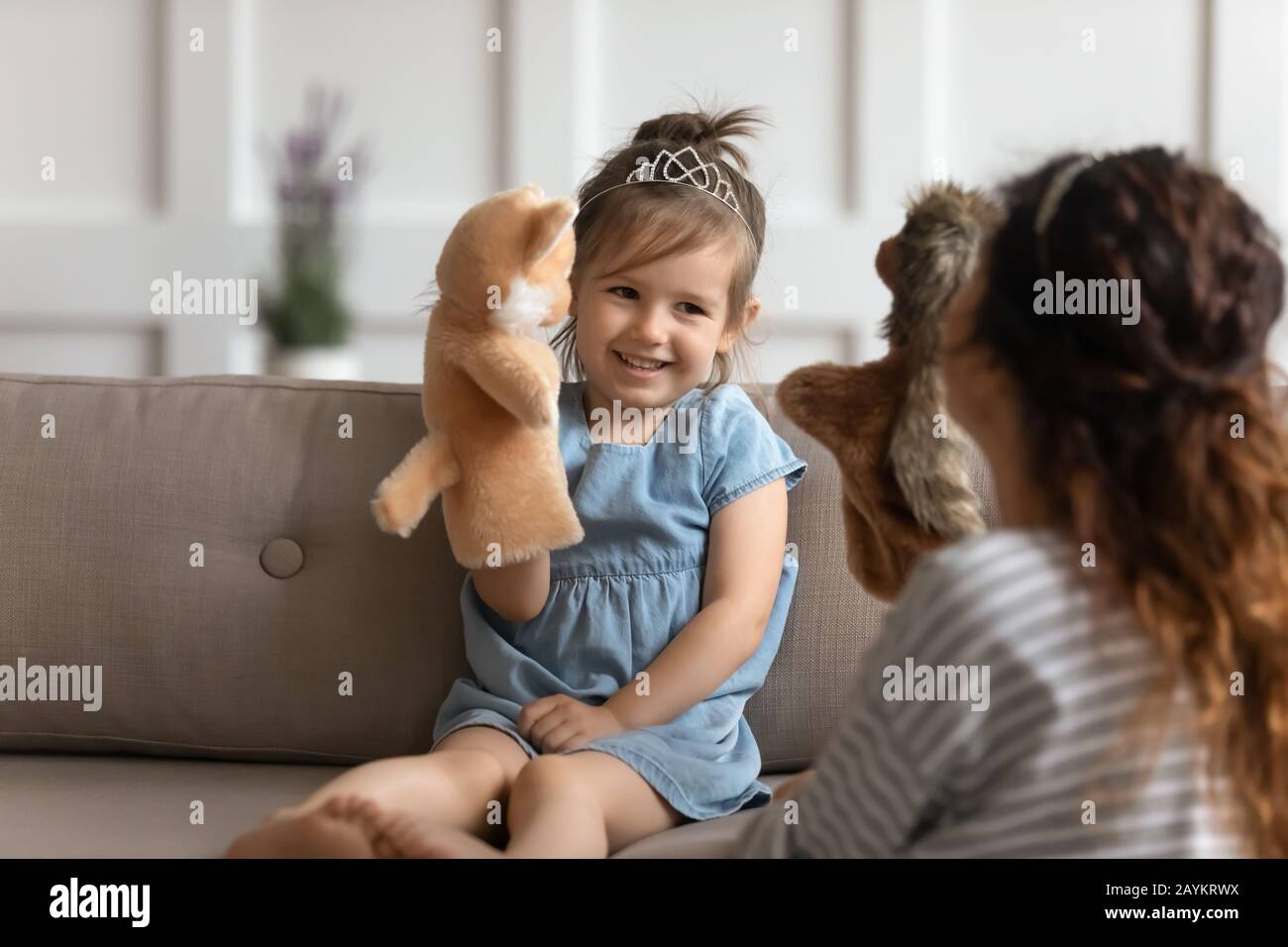 Happy small preschool kid girl playing with nanny Stock Photo - Alamy