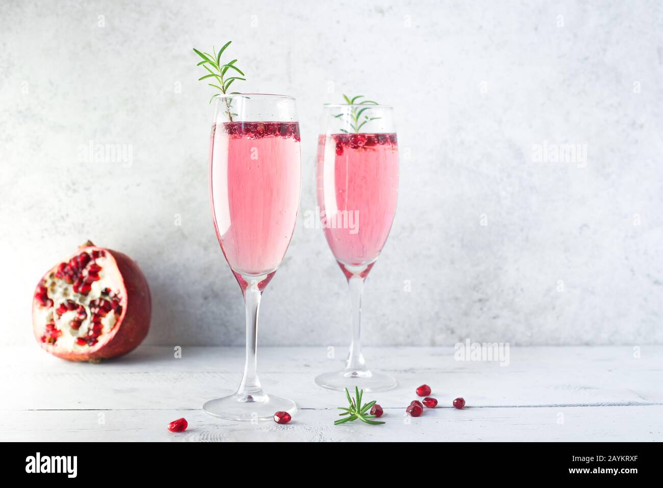 Mimosa cocktail with Rose Champagne, Pomegranate and Rosemary in flute ...
