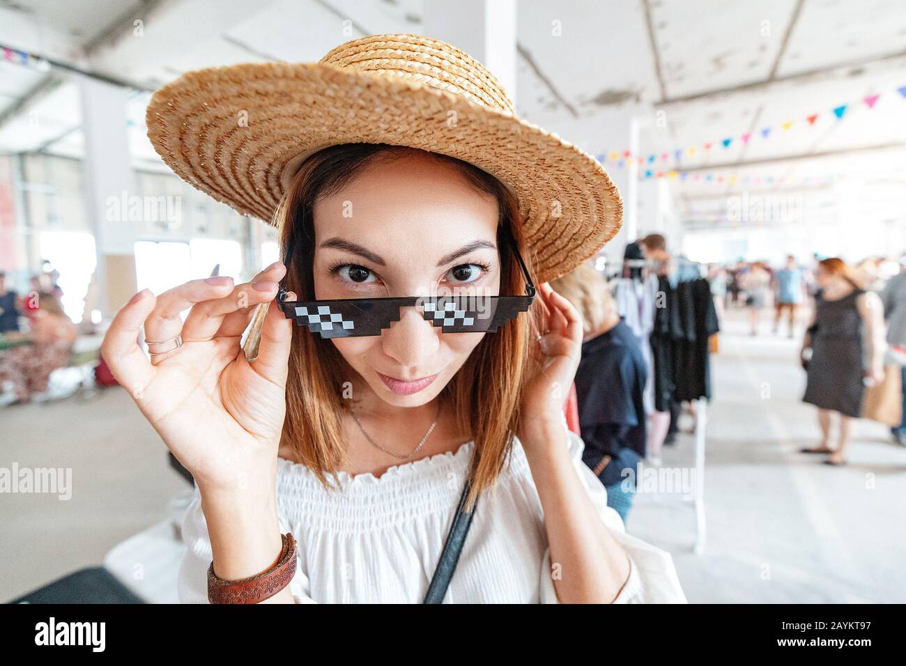 Funny girl trying on hilarious stylish sunny gangsta glasses in a store ...