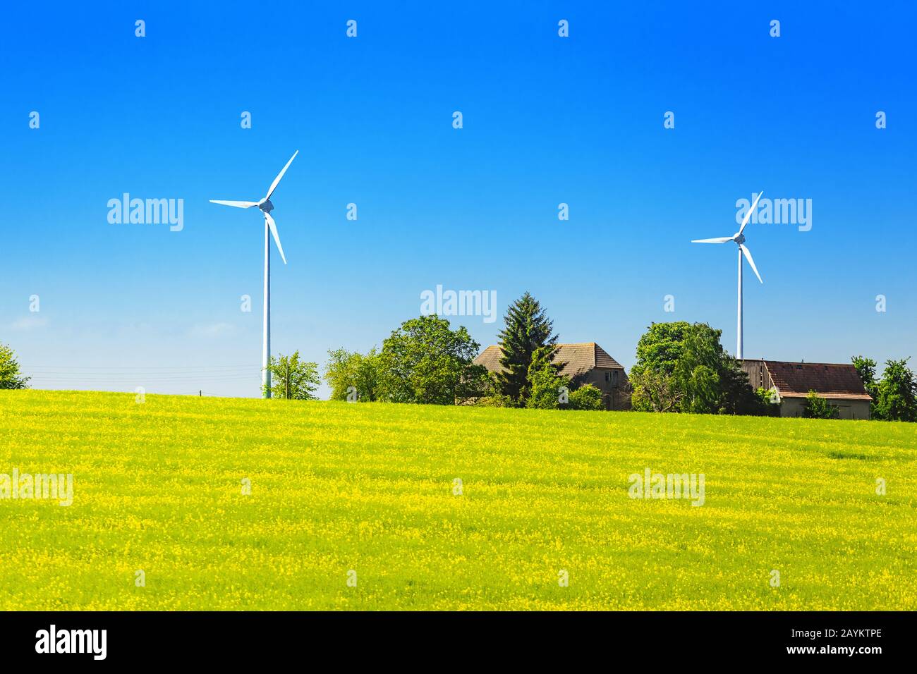 wind turbines located on farm land near crop field in the foreground ...