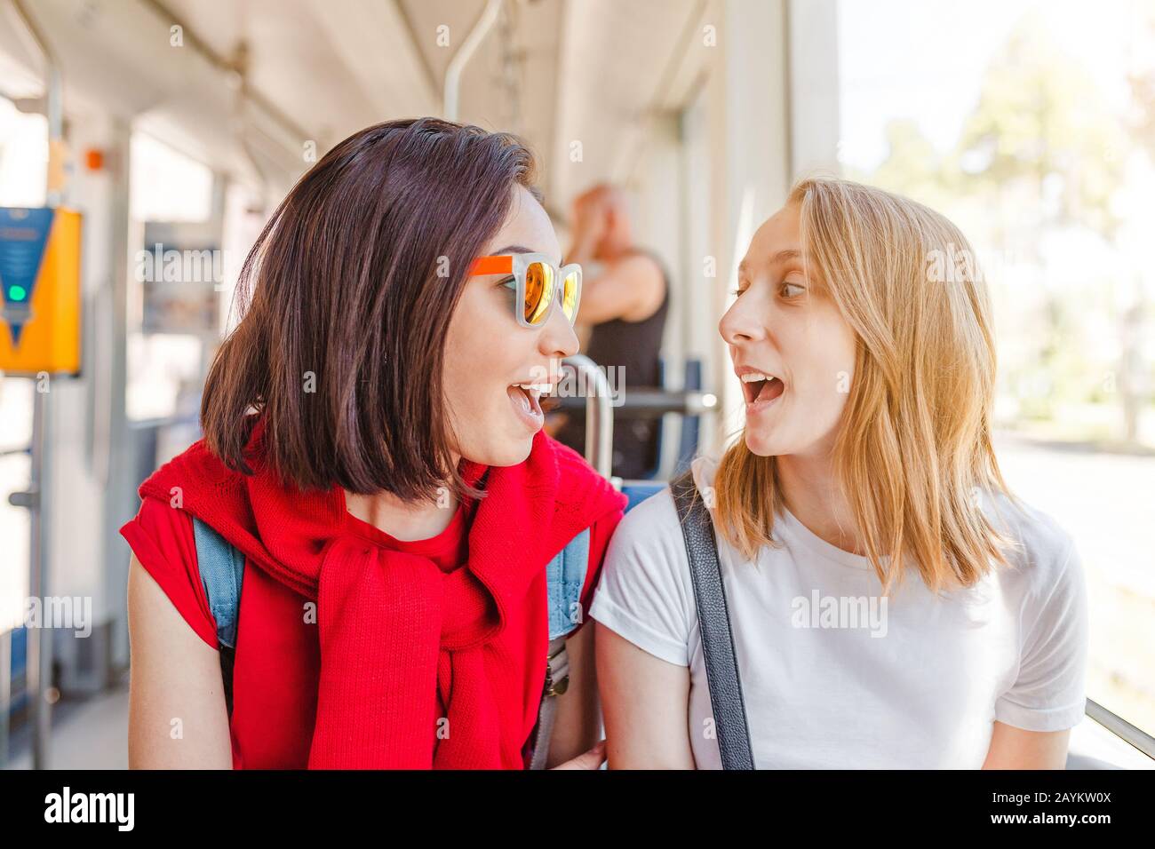 Two Young Women On Bus Journey Together and chatting, friendship and ...