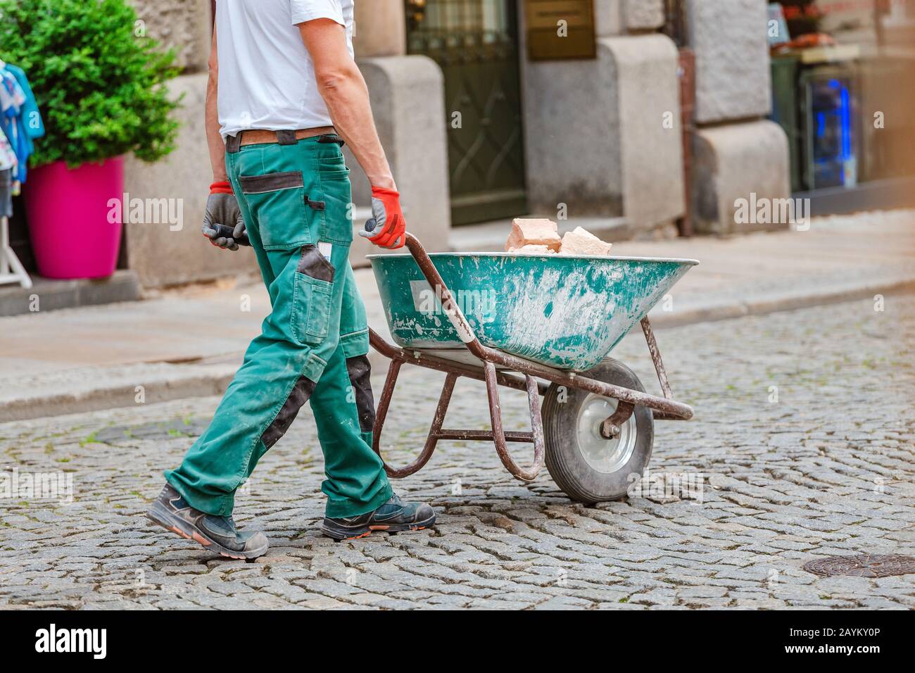 industrial worker with wheelbarrow cart full of bricks, job at ...