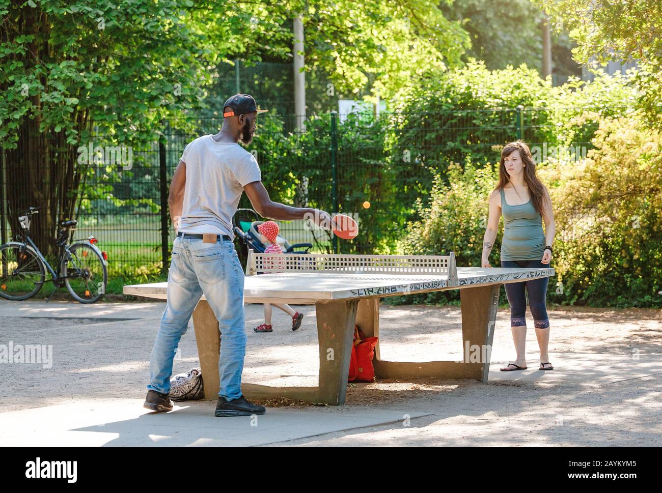 22 MAY 2018, LEIPZIG, GERMANY: multiracial couple playing ping pong ...