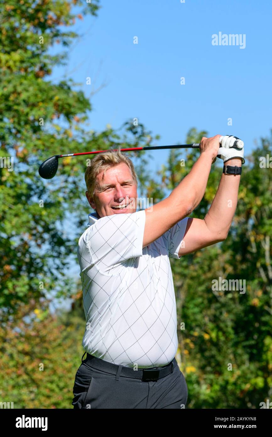 Man having fun while playing golf Stock Photo - Alamy