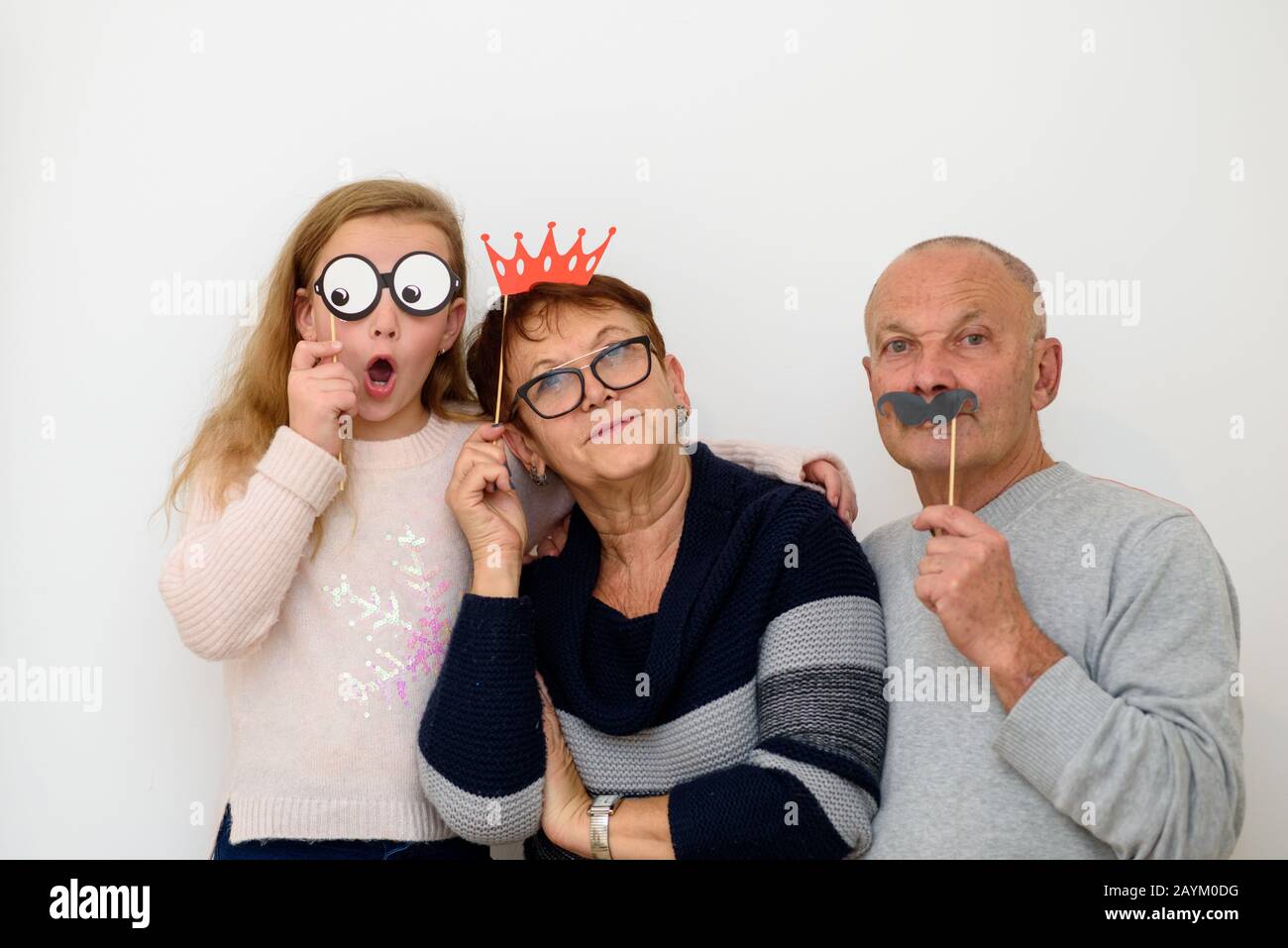 Grandmother and Grandfather with paper mask having fun with grandchild ...