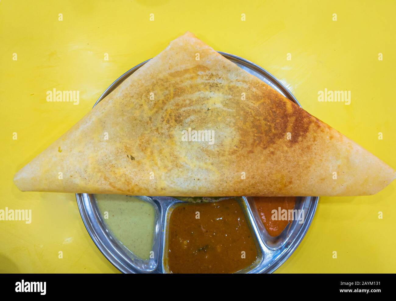 A Dosa is a Famous South Indian Food, cooked flat thin layered rice ...