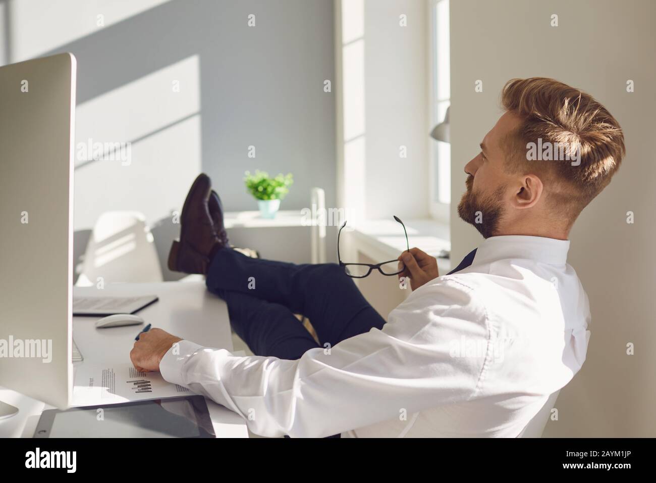 Businessman resting relaxes meditating dreams at the workplace at the ...