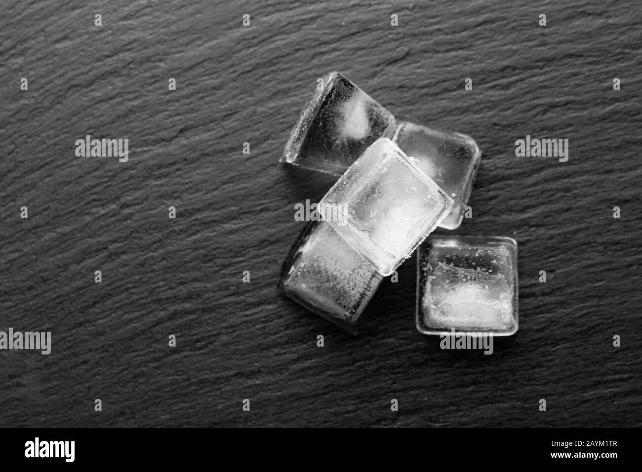 ice cubes on black slate board Stock Photo - Alamy