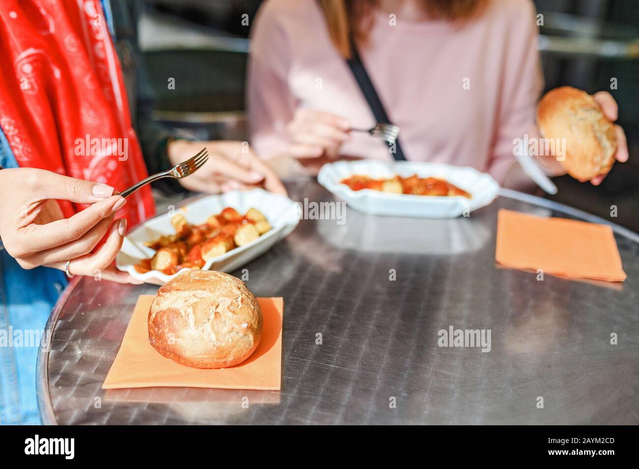Woman Eating Currywurst with bread in Berlin street food cafe. Local ...