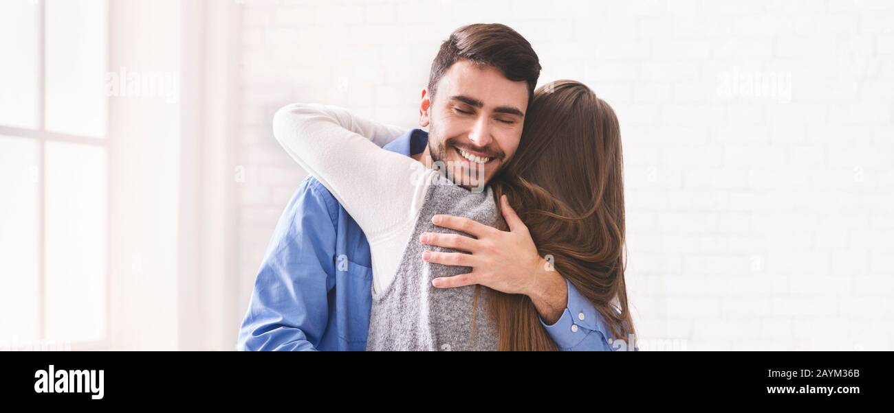 Happy couple in love embracing indoors, man and woman hugging tightly ...