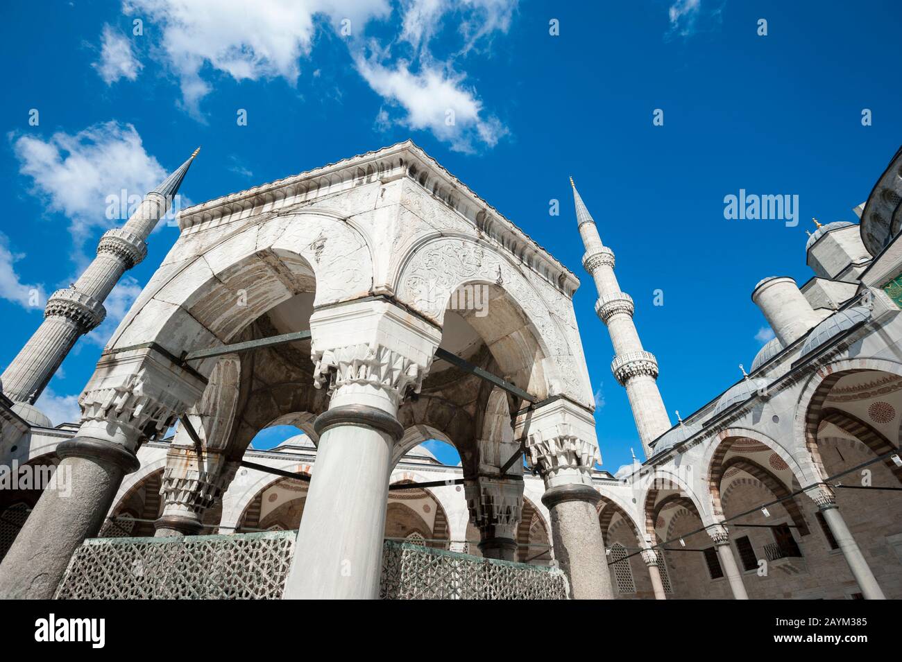 Minarets frame the hexagonal ablution fountain in the center of an ...