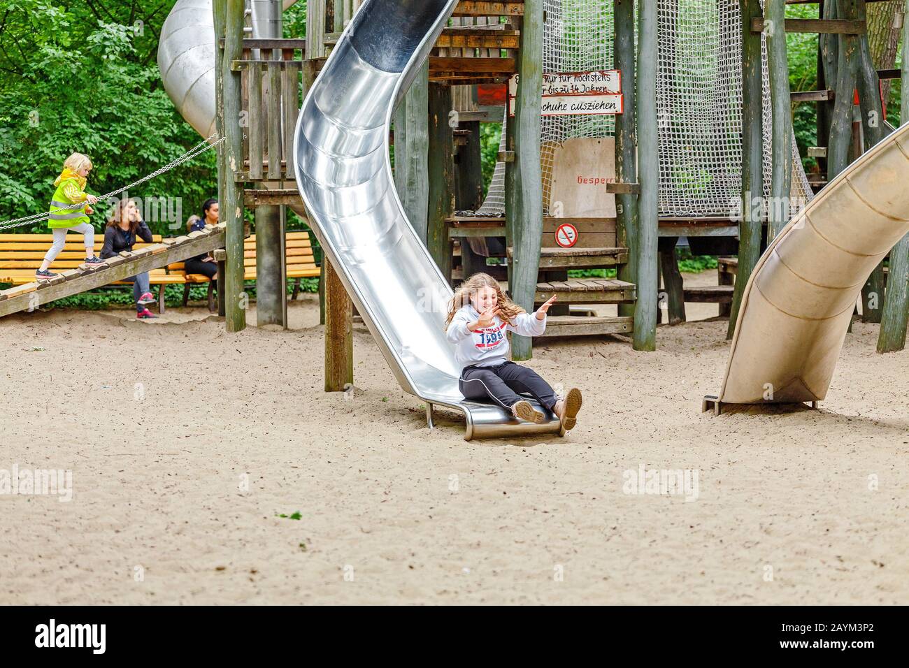 18 MAY 2018, BERLIN, GERMANY: happy children enjoying slides on new ...
