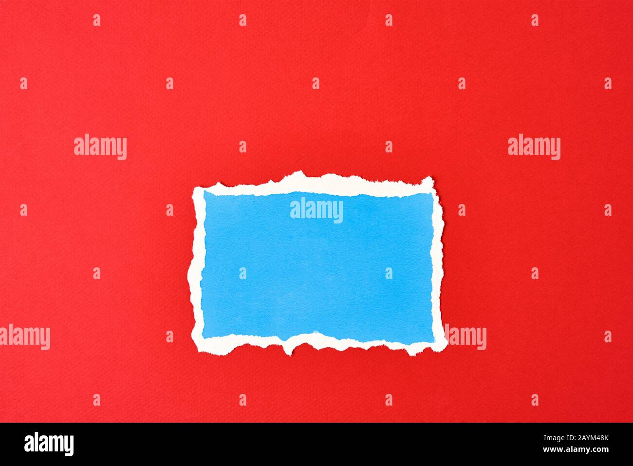 Ripped blue paper torn edge sheet on red background. Template with ...