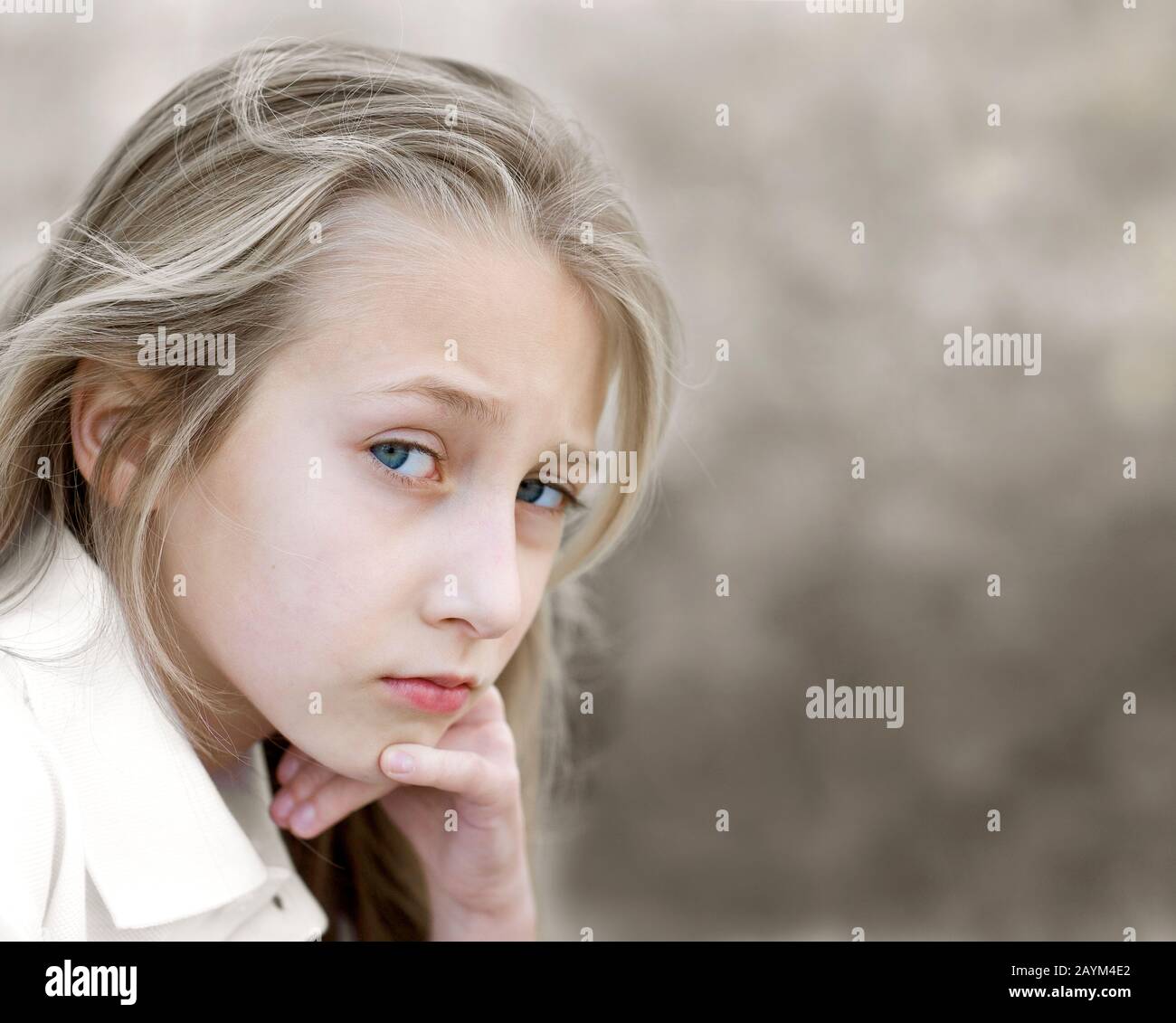 An introspective pretty young girl with blond hair and blue eyes Stock ...