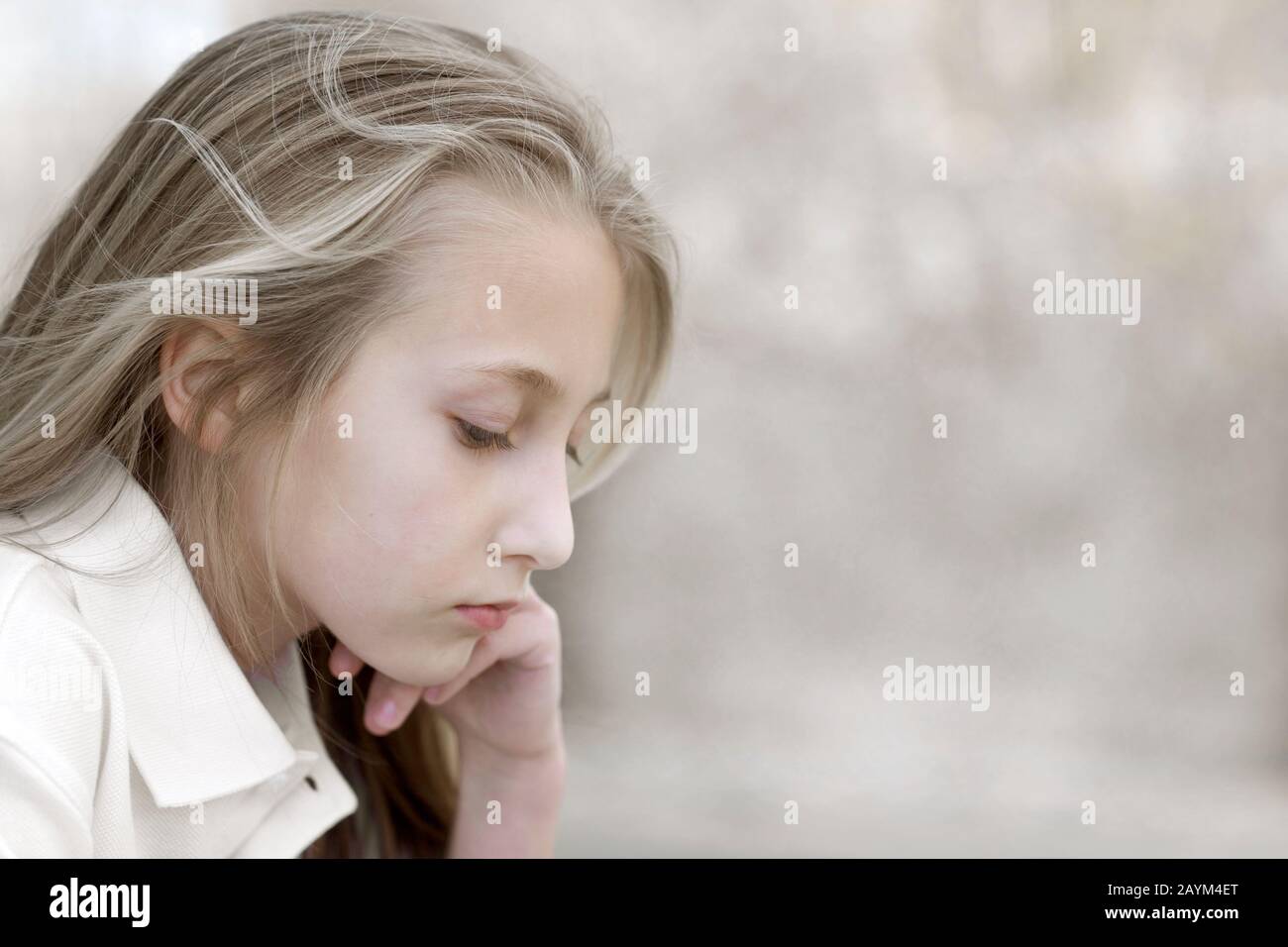 An introspective pretty young, fair skinned girl with blond hair and ...