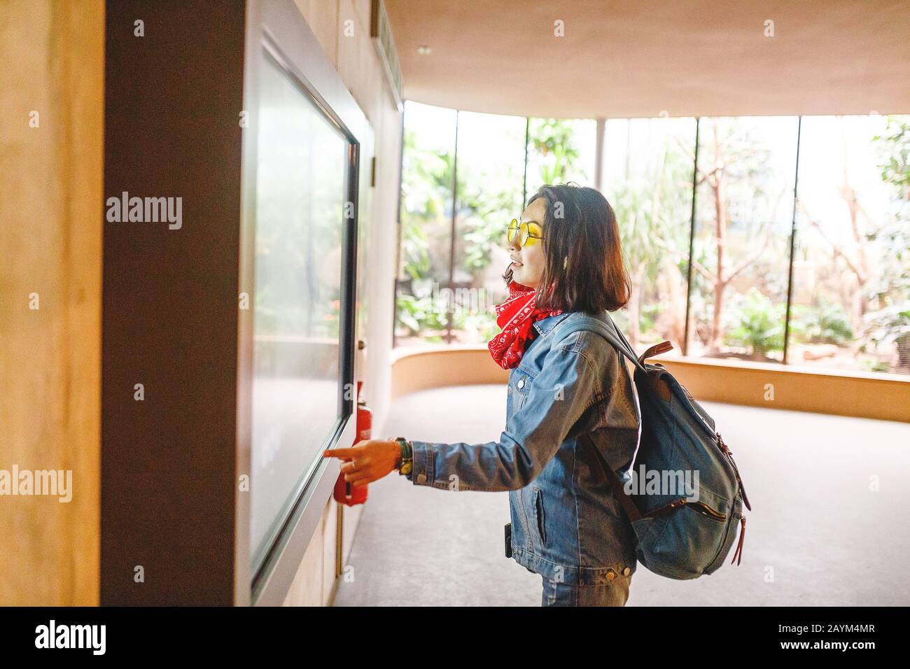 Woman use interactive modern touch screen monitor in zoological garden ...