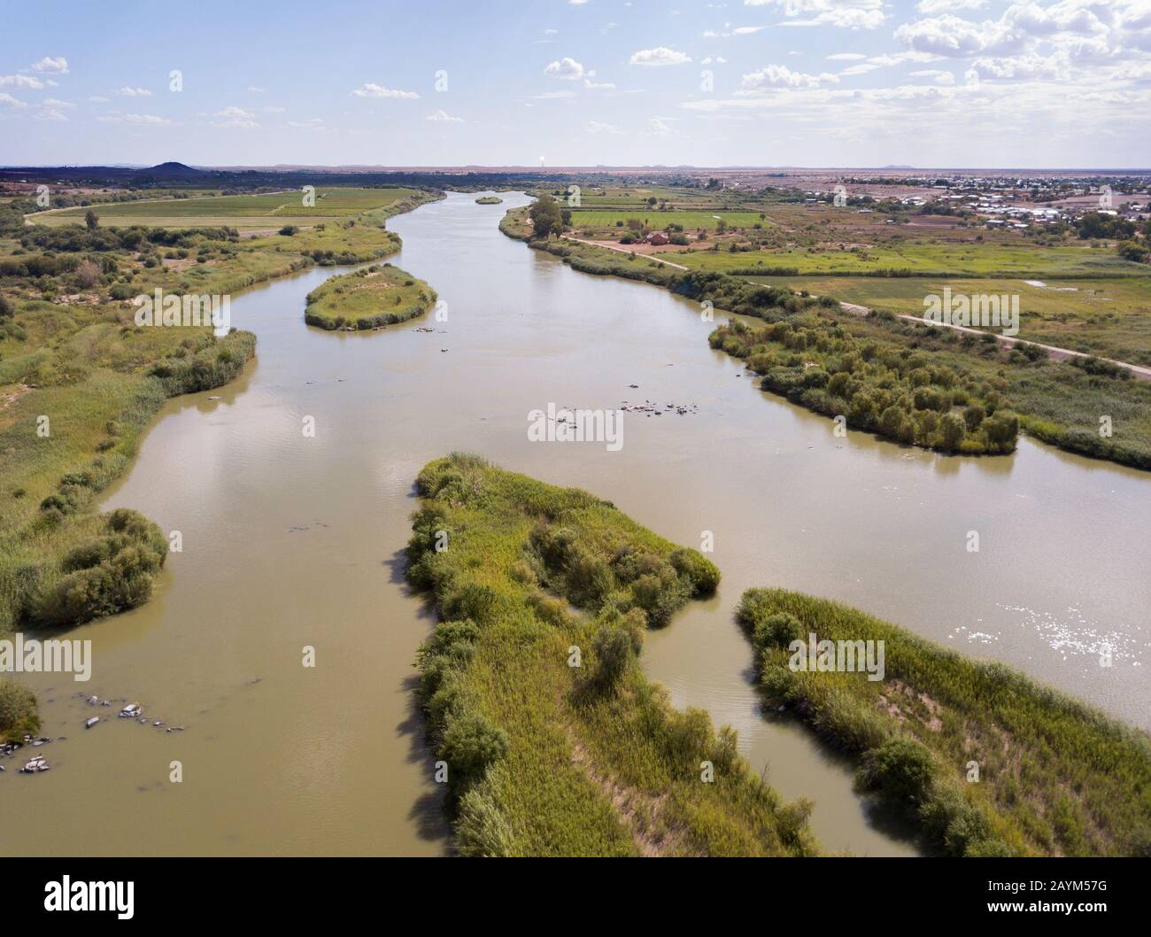 Large river flowing through farmlands in a flat landscape Stock Photo ...
