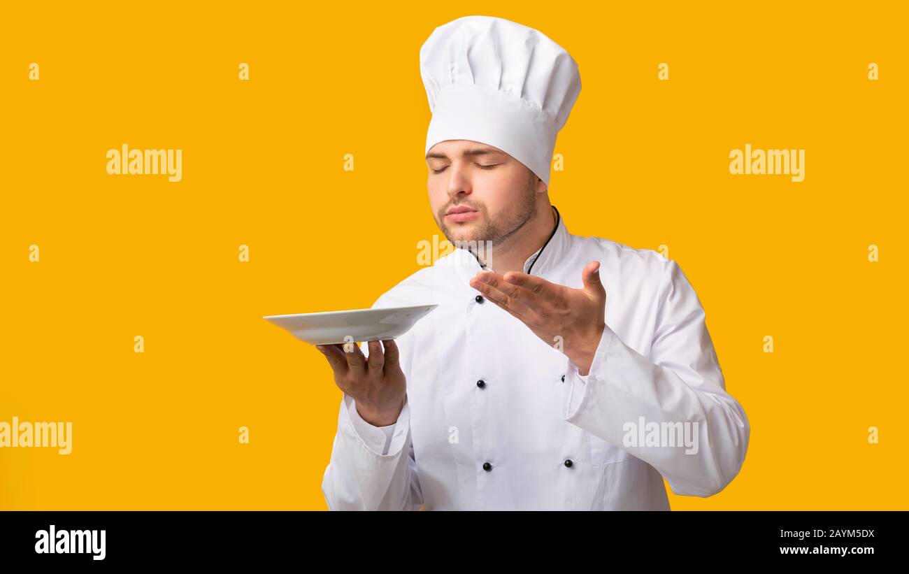 Chef Man Smelling Invisible Dish Holding Empty Plate, Studio, Panorama ...