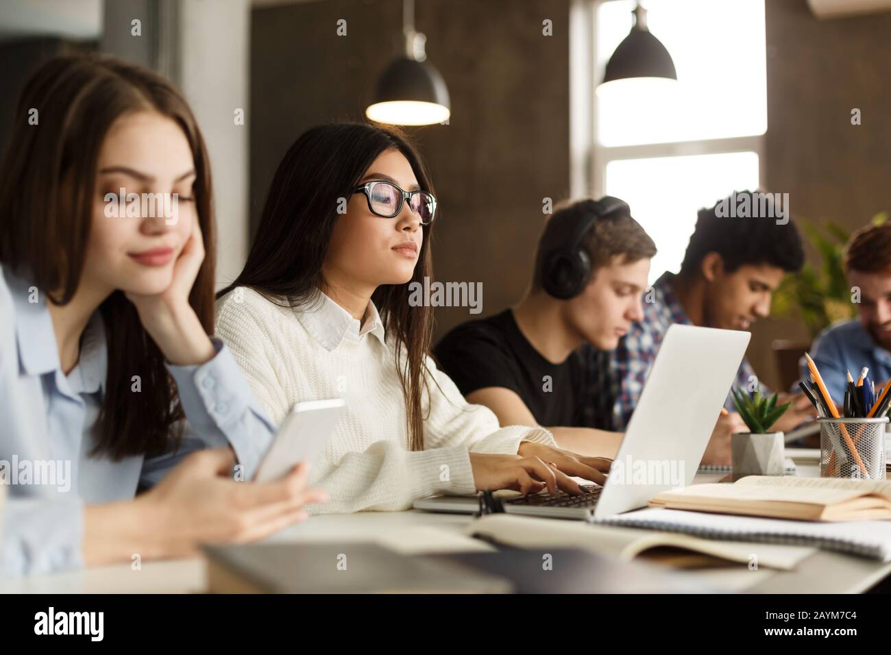 Education concept. Student girl studying in library interior Stock ...