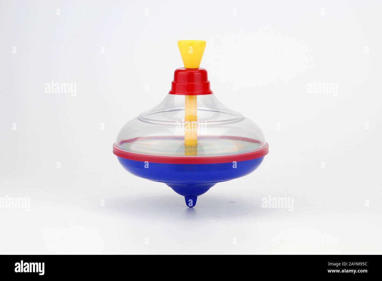Beautiful peg top toy spinning on white background. Spinning top in ...