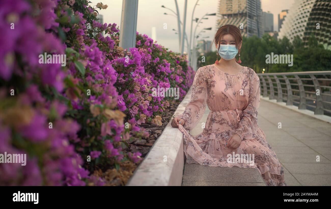 Asian Chinese girl wearing a surgical face mask to protect herself from ...