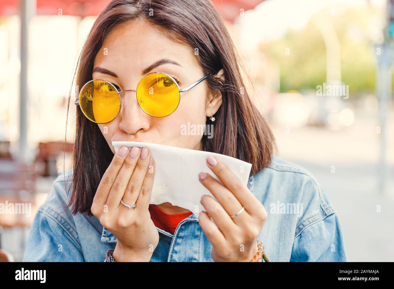 Asian woman wiping her mouth after a meal Stock Photo - Alamy