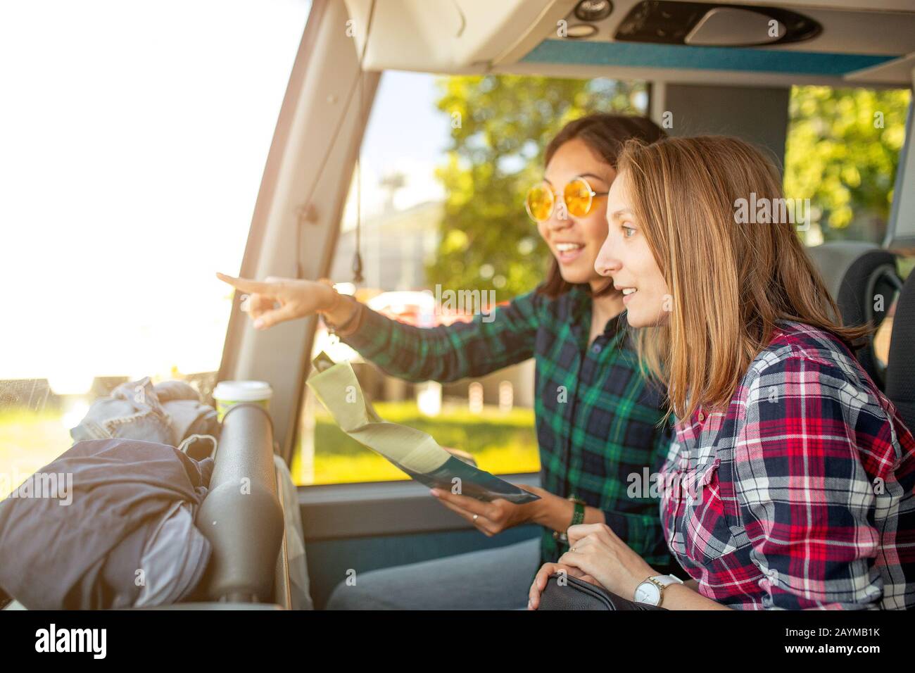 Two girls travel by bus in Europe, public transport, trip and vacation ...