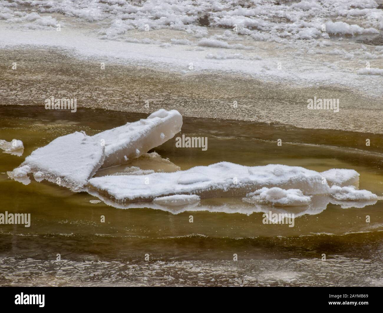 winter picture with ice cubes in river, reflections in water Stock ...