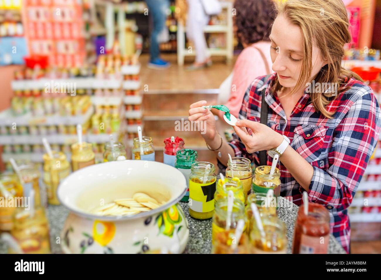Portrait of a young model tasting various flavours of mustard Stock ...