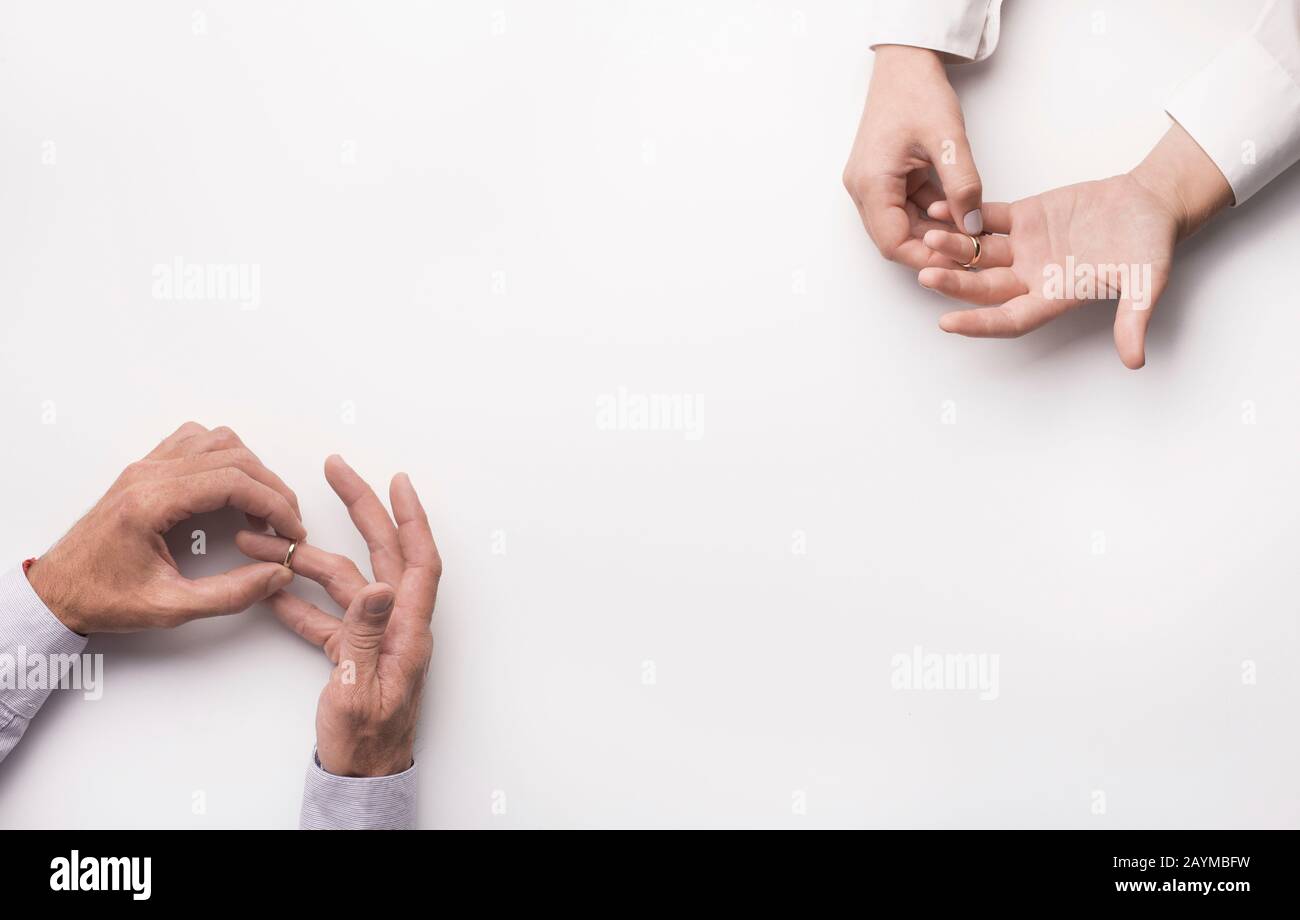 Couple husband and wife taking off wedding rings Stock Photo - Alamy