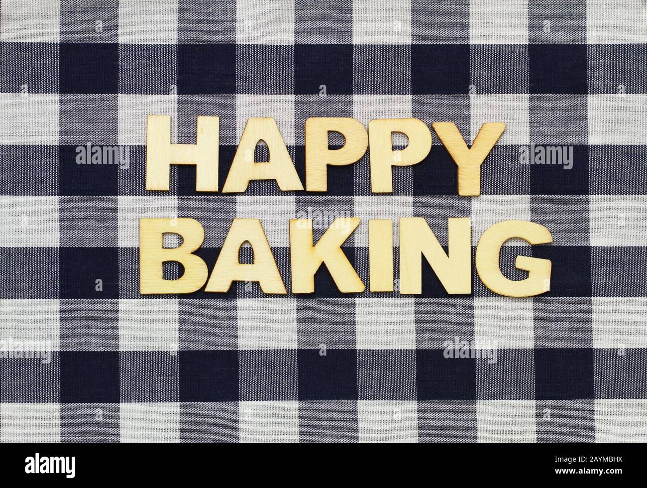 Happy baking written with wooden letters on navy blue and white ...